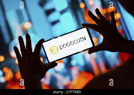 In this photo illustration, the Dogecoin logo is seen displayed on a ...