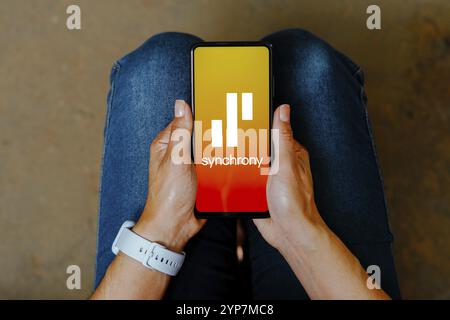 In this photo illustration, the Synchrony logo is displayed on a ...
