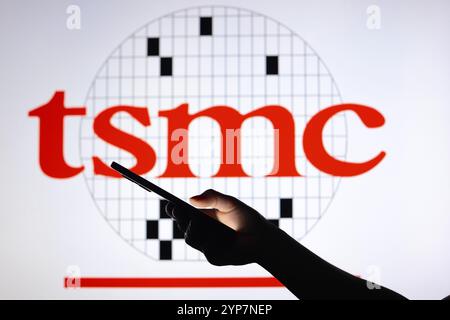 In this photo illustration, a Tsmc logo is seen displayed on a ...