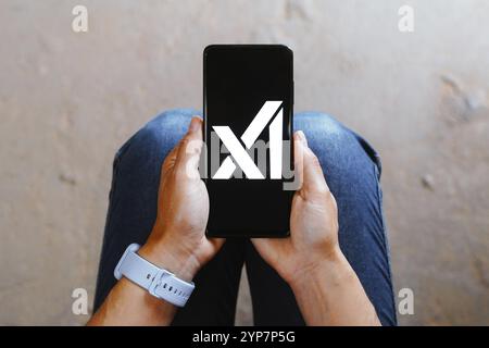In this photo illustration, the xAI logo is displayed on a smartphone ...