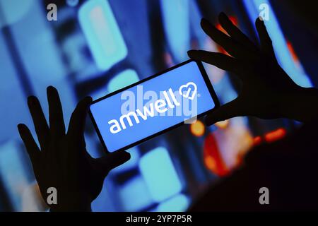 In this photo illustration, the Amwell logo seen displayed on a ...