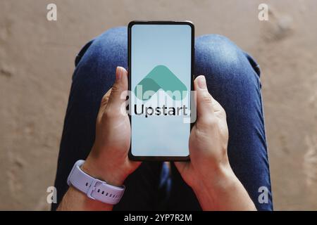 In this photo illustration, the Upstart logo is displayed on a ...