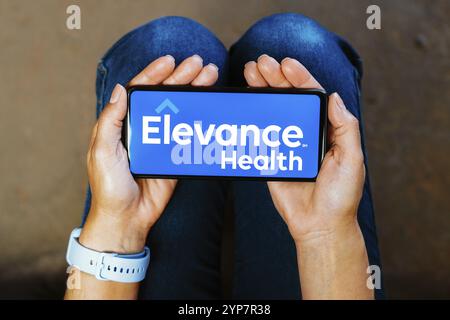 In this photo illustration, the Elevance Health logo is seen displayed ...