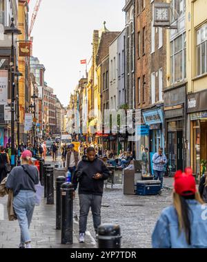 Bustling Soho street scene with pedestrians in London Stock Photo - Alamy