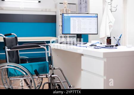 Doctors office with an unoccupied table and desktop pc screen showing ...