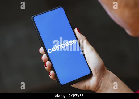 In this photo illustration a Coinbase logo seen displayed on a ...