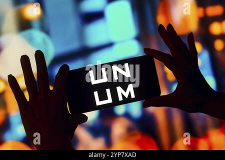 In this photo illustration, the Unum Group logo is seen displayed on a ...