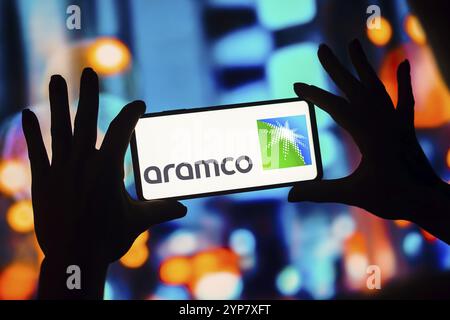 In this photo illustration, an Aramco logo is seen displayed on a ...