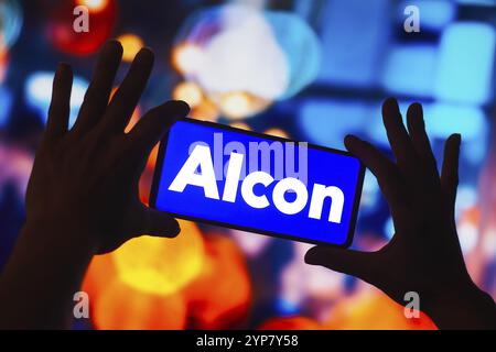 In this photo illustration, the Alcon logo is displayed on a smartphone ...