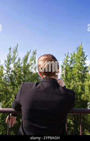 Business people looking out from rooftop Stock Photo - Alamy