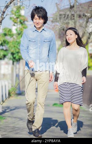 Japanese Couple Taking A Walk In The Park Stock Photo - Alamy
