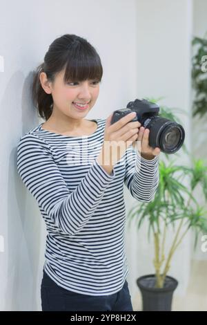 Woman checking photos taken Stock Photo - Alamy
