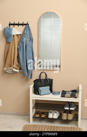 Coat rack with clothes, mirror, shoe storage bench and chest of drawers ...