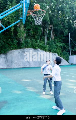 Secondary school students playing basketball Stock Photo - Alamy