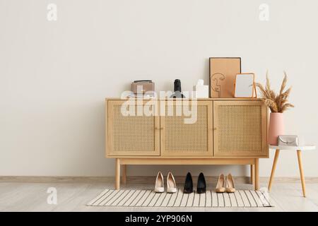 Interior of hallway with commode, table and shoes Stock Photo - Alamy