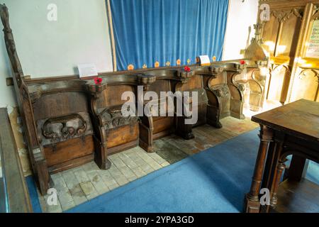 Carved decorated wooden misericord seats in church at Framsden, Suffolk ...
