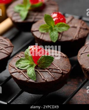 Chocolate brownie cake topped with cherries and mint leaves Stock Photo ...
