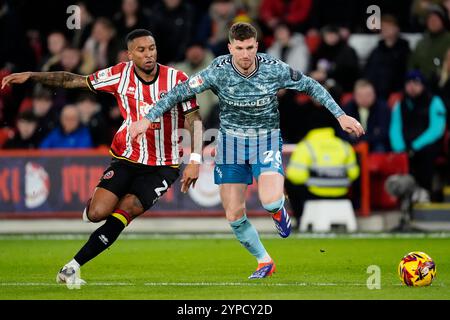 Sunderland's Chris Mepham (left) and Sheffield Wednesday's Josh Windass ...