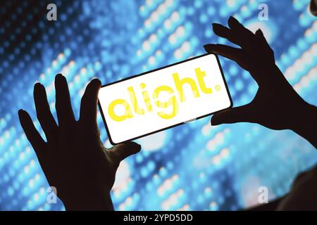 In this photo illustration, the Alight Solutions logo is displayed on a ...