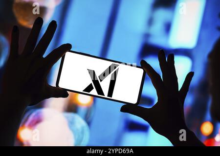 In this photo illustration, a XaI logo is displayed on a smartphone ...