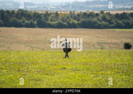 army soldier with gun on a 40kg loaded march tab military exercise ...