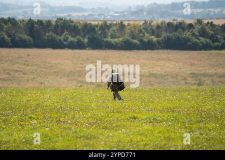 army soldier with gun on a 40kg loaded march tab military exercise ...