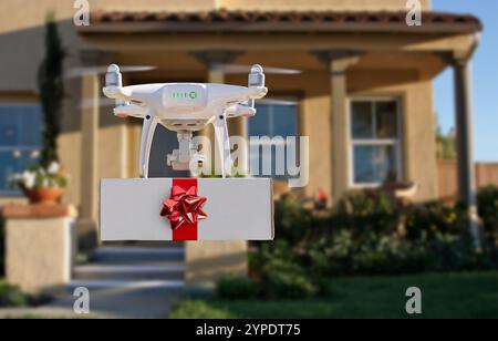 Unmanned UAV Quadcopter Drone Delivering Box With Red Bow and Ribbon To ...