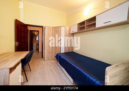 Simple standard hotel room interior featuring two single twin beds ...