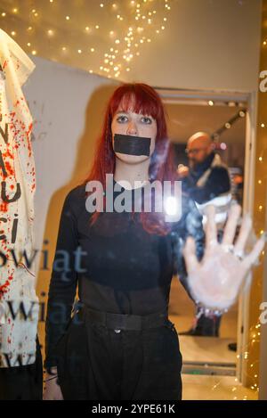 A protester's hand is seen glued to the window during a demonstration ...