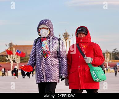 Tourists wear thick clothes to visit the Tiananmen Square in Beijing ...