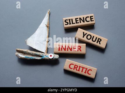 Silence your inner critic symbol. Wooden blocks with words Silence your ...
