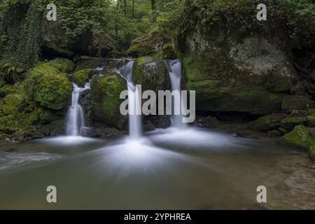 Cascade shooting pond, waterfall under small pedestrian bridge ...