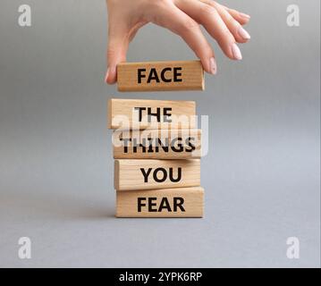 Face the things you fear symbol. Wooden blocks with words Face the ...
