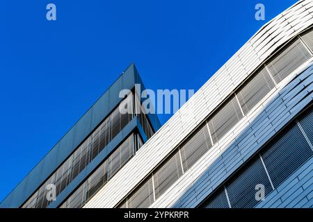 Modern Architectural Design with Curved and Angular Facades Against a ...