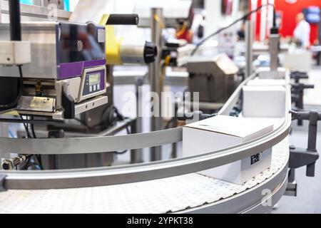Packages boxes on conveyor during automated production manufacturing ...