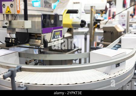 Packages boxes on conveyor during automated production manufacturing ...