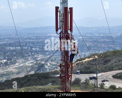 Engineer with safety equipment on high tower for working telecom ...