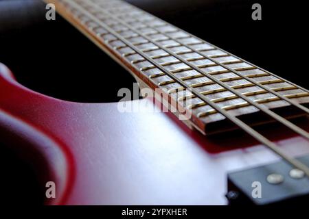 A close up of a bass guitar being played during a live performance of ...