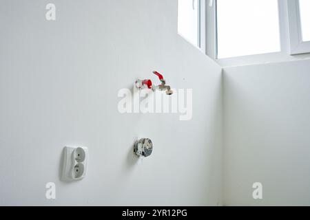 Water pipes and electrical outlets installed in new apartment during ...