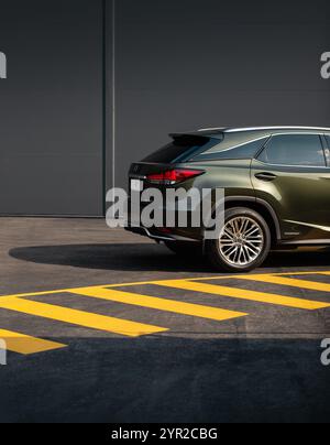 Green Lexus RX in urban setting. Front three quarter view of japanese ...