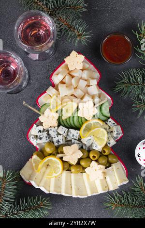 slice of dor blue cheese with olives and herbs on wooden background ...