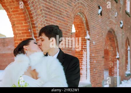 The newlyweds kiss in a beautiful picturesque gazebo against the ...