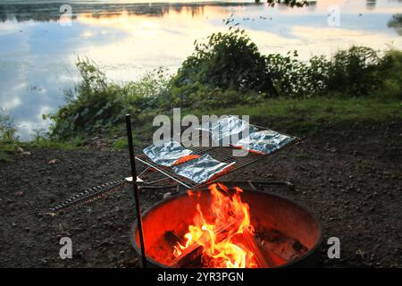 Cooking Foil Packs Over An Open Fire At The Campsite Stock Photo - Alamy