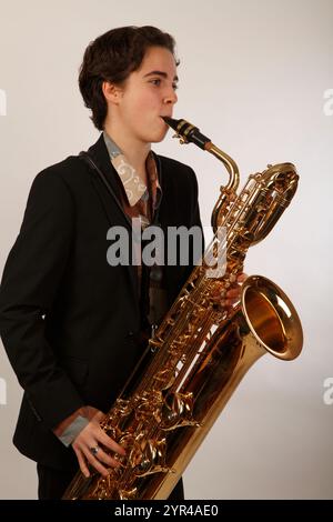 Young Musician holding or playing a baritone saxophone Stock Photo - Alamy