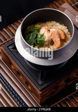 Japanese kamameshi rice dish cooked in an iron kama pot with ikura red ...