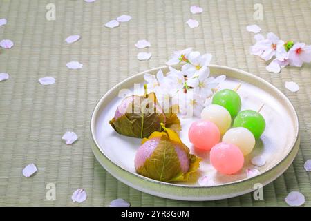 Spring Japanese sweets and cherry petals Stock Photo - Alamy