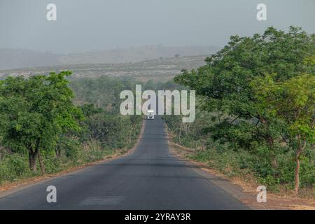 Peaceful Rural Road in Togo Surrounded by Dense Trees and Rolling ...