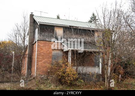 Abandoned brick houses on a green field on a cloudy day Stock Photo - Alamy