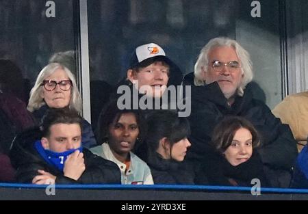 Singer songwriter Ed Sheeran (right) watches the action during day six ...