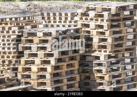 wooden pallets stacked upon each other in a warehouse. factor ...